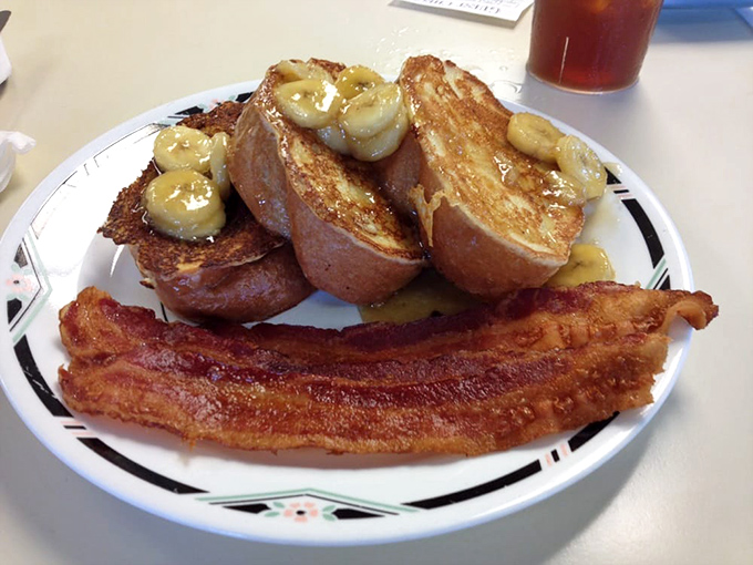 French toast that's having a banana party! Those caramelized slices alongside perfectly crisp bacon create the breakfast equivalent of a standing ovation.