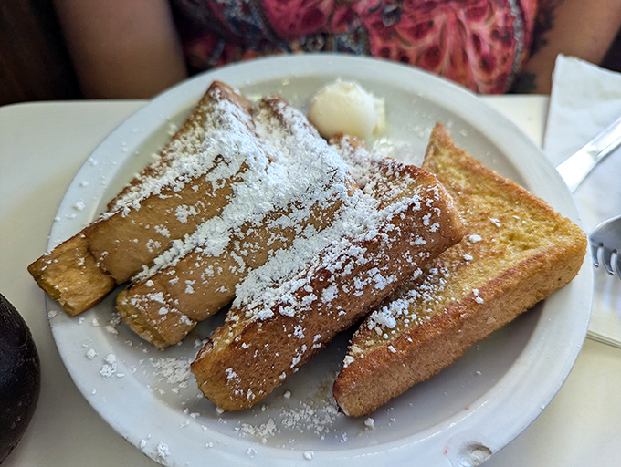 Golden slices of French toast dusted with powdered sugar&mdash;proof that sometimes the simplest pleasures are the most profound. This isn't breakfast; it's edible nostalgia.