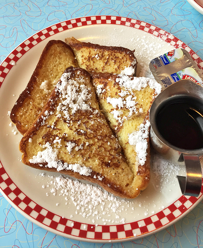 Golden-brown French toast dusted with powdered sugar like the first perfect snowfall of winter. Worth every single calorie. 