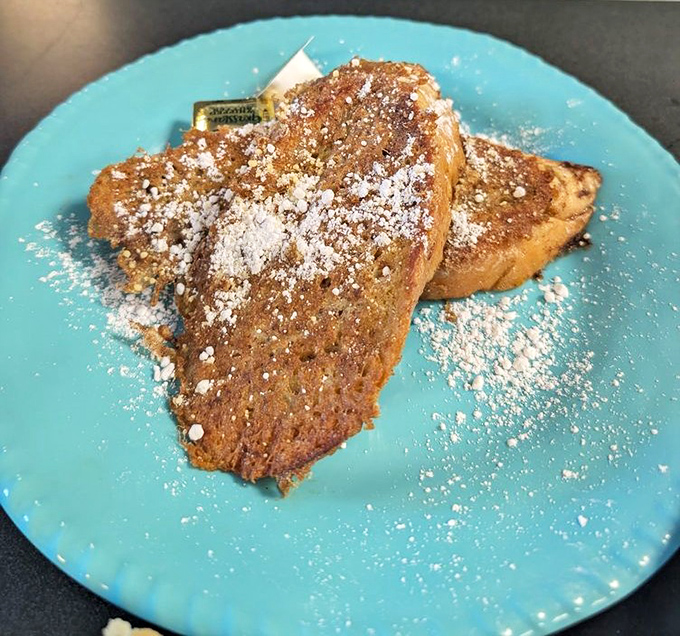 Golden-brown French toast dusted with powdered sugar &ndash; simple perfection that doesn't need fancy garnishes to shine.
