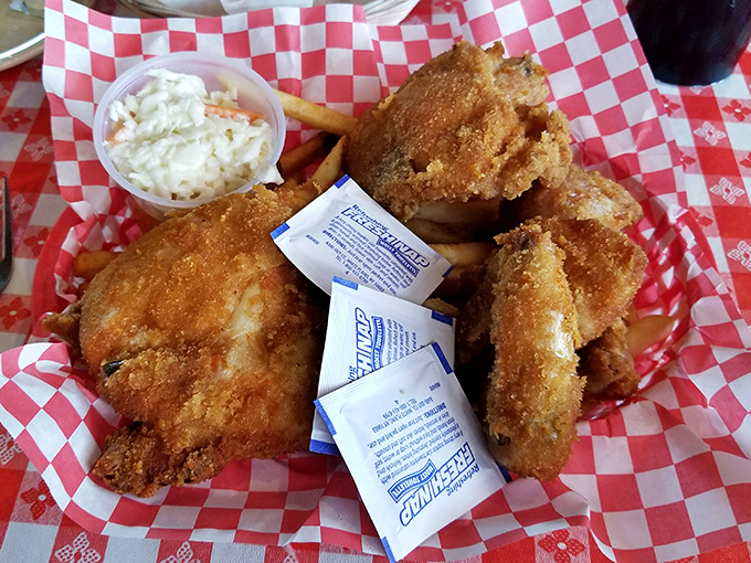 Golden perfection arrives on red checkered paper, proving that some miracles come with coleslaw on the side.