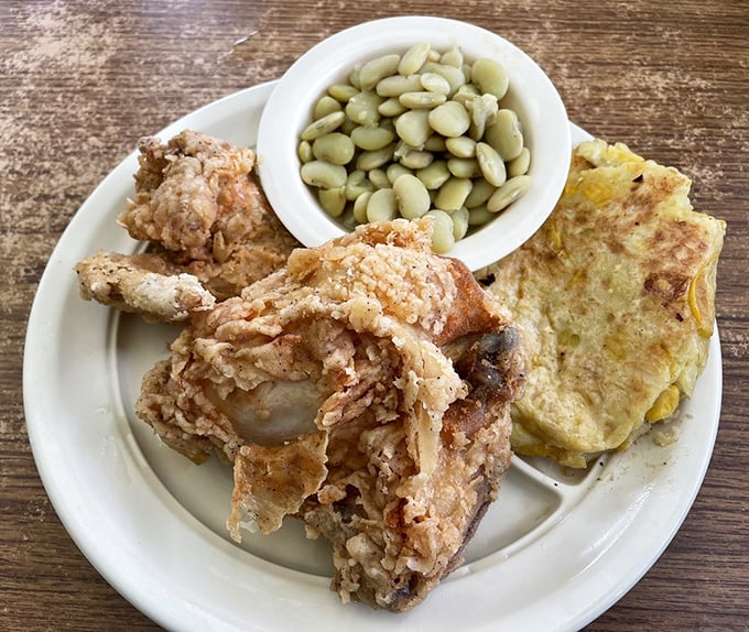 Golden-brown fried chicken that crackles with each bite, paired with lima beans and cornbread—a Southern trinity worth worshipping.