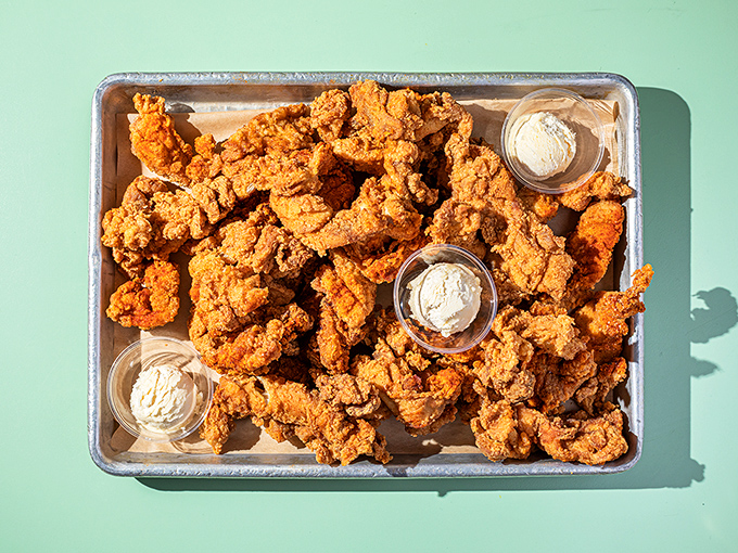 Golden-brown perfection on a metal tray, with those little cups of honey butter standing by like flavor bodyguards.