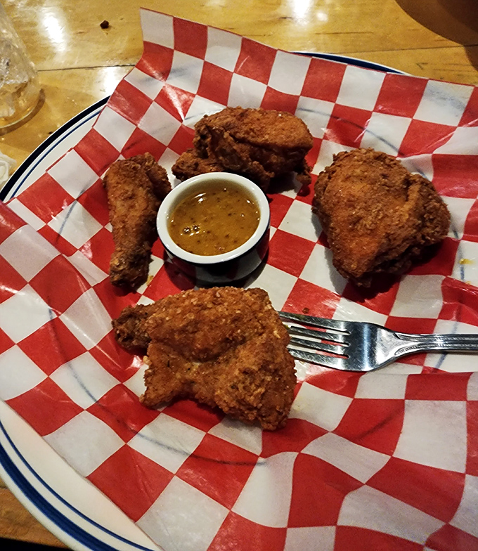 This fried chicken doesn't need a fancy introduction&mdash;it speaks fluent delicious with its golden-brown crust and juicy interior. Poetry on a checkered paper.