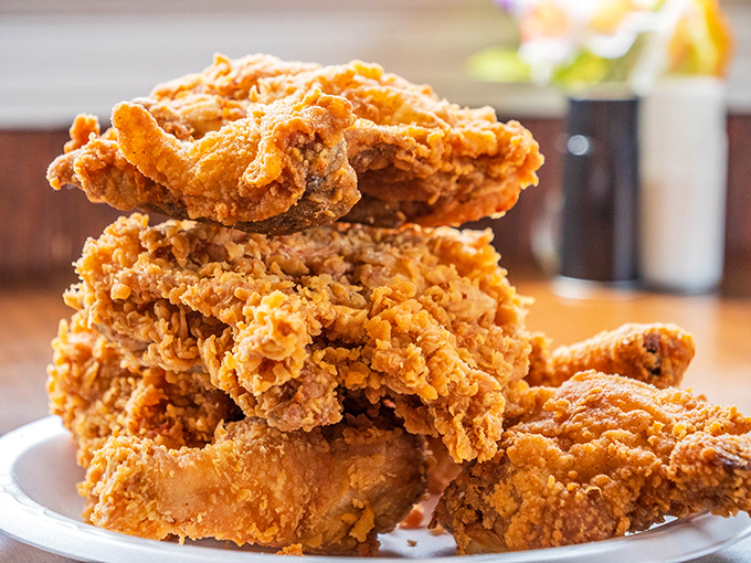 Golden-brown perfection stacked high like a delicious Jenga tower. This isn't just fried chicken; it's edible artwork with a PhD in crispiness.