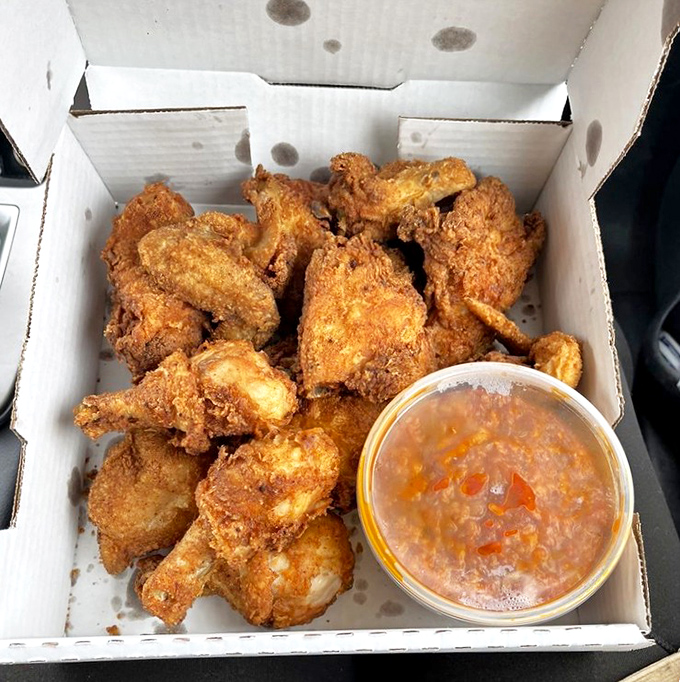 Golden-brown perfection in a box. This isn't just fried chicken; it's edible artwork with a side of heavenly dipping sauce.