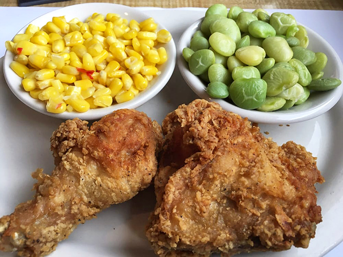 Golden-brown fried chicken that crackles with each bite, flanked by buttery corn and lima beans that grandma would approve of.