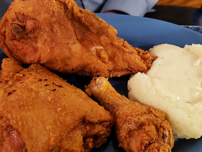 Golden-brown perfection that would make Aunt Bee proud! This crispy, juicy fried chicken pairs with creamy mashed potatoes for a plate of pure Midwest comfort.