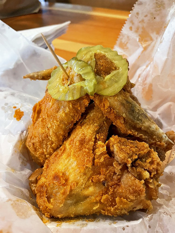 Golden, crispy perfection topped with pickle coins that serve as both garnish and emergency coolant when things get too spicy.