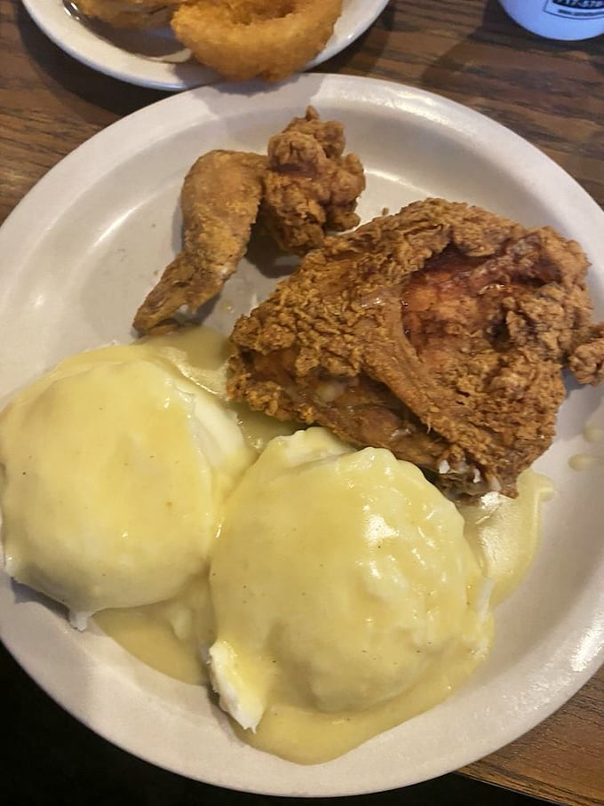 Golden-fried chicken that crackles with each bite, paired with mashed potatoes so creamy they could make a cardiologist weep with joy.