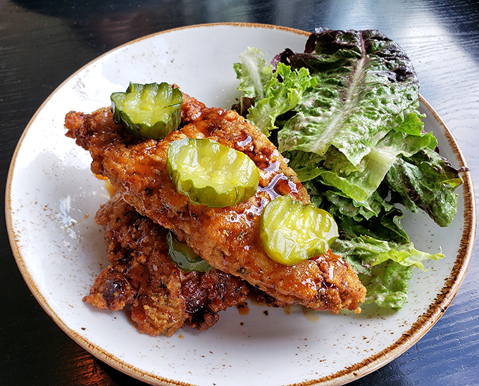 This isn't just fried chicken; it's a masterclass in texture. The pickle chips add that perfect acidic counterpoint to the crispy, spicy coating.
