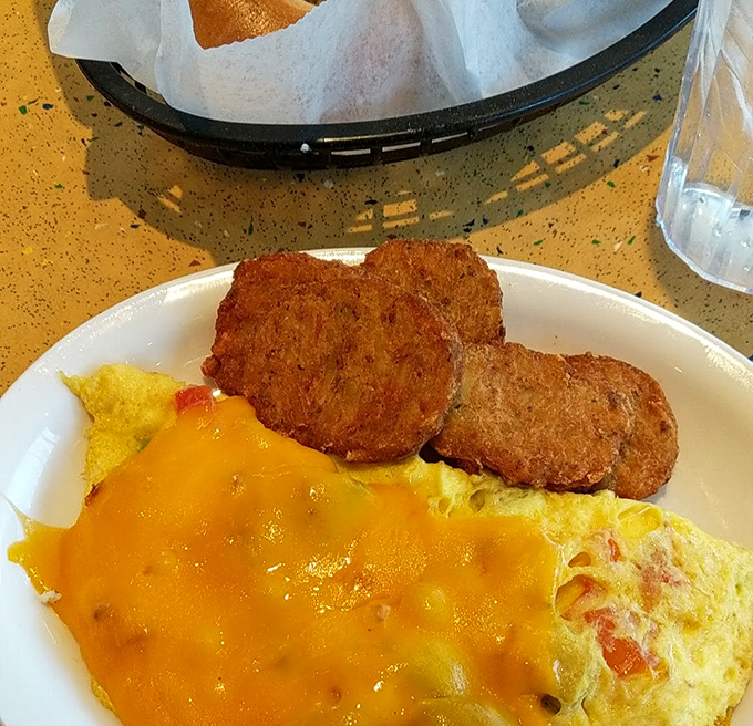 Golden-brown fried green tomatoes alongside a cheesy omelet&mdash;proof that Southern comfort and deli traditions can create the perfect breakfast marriage.