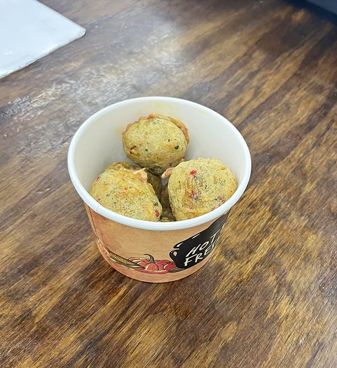 These golden-brown bites might not win any beauty contests, but they'll win your heart. Savory little spheres of comfort nestled in a paper cup.