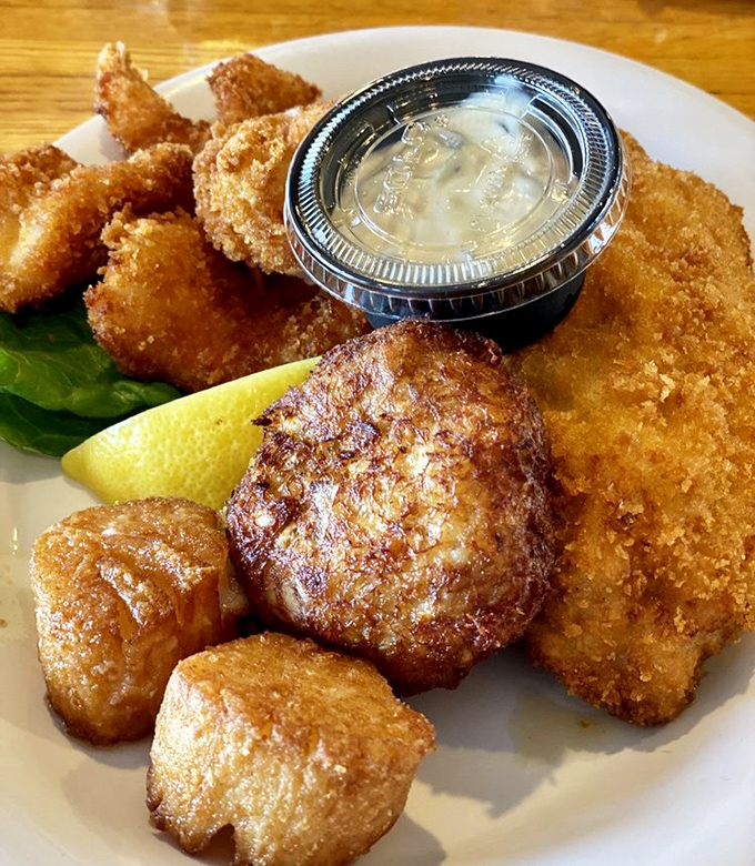 This golden-fried seafood platter isn't just food – it's edible sunshine with a crunchy exterior and sweet, tender treasures inside.