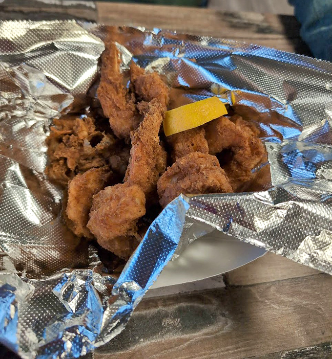 Golden-fried shrimp that make you understand why people drive for hours. That perfect crunch gives way to sweet, tender seafood heaven.