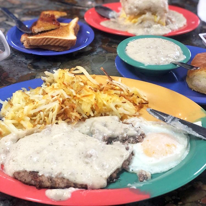 The legendary chicken fried steak in all its glory&mdash;tender meat under crispy breading, smothered in pepper gravy alongside golden hashbrowns. Pure bliss!