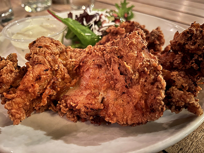 Golden-brown perfection that shatters at first bite, revealing juicy meat beneath—this fried chicken might just ruin you for all others.