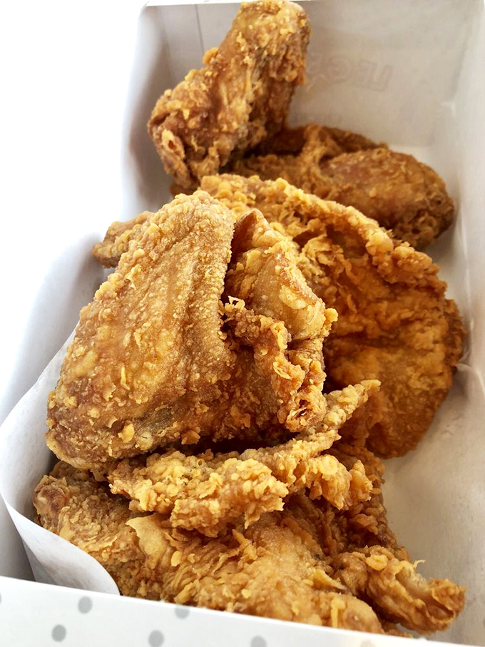 Golden-brown perfection in a box. This isn't just fried chicken; it's edible artwork with a PhD in crunchology. 