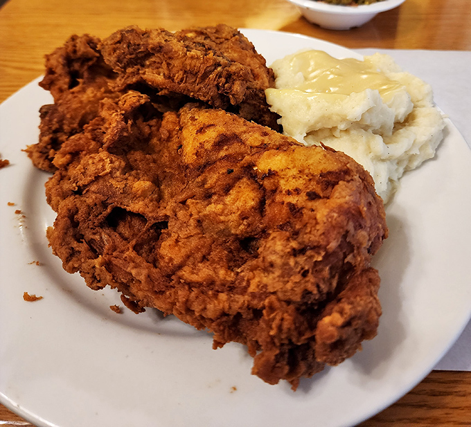 Behold the star attraction: fried chicken with a crust so perfectly golden and crispy, it deserves its own theme music.