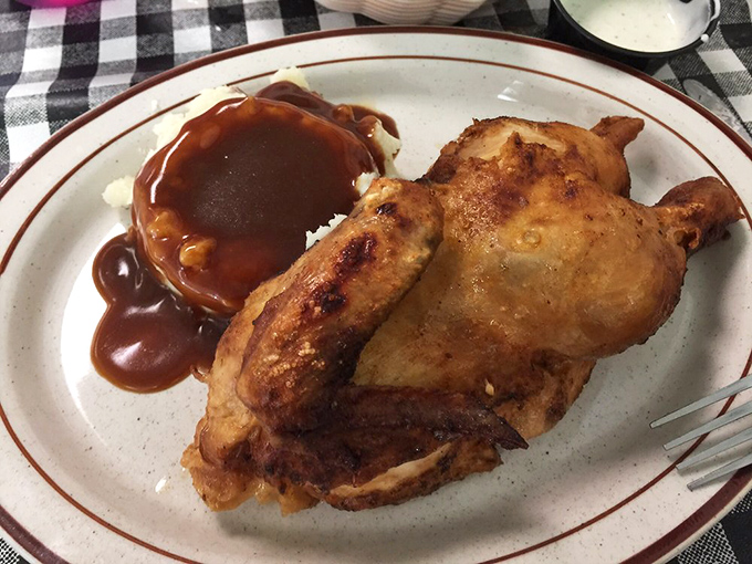 Fried chicken so perfectly golden it deserves its own trophy. That gravy pool isn't just sauce&mdash;it's a flavor lagoon waiting to be explored.