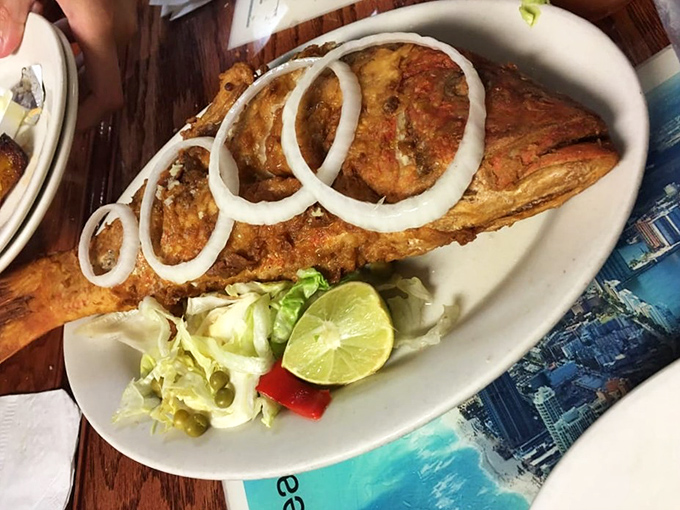 This fried snapper arrives dressed to impress, wearing onion rings like jewelry and ready for its close-up.