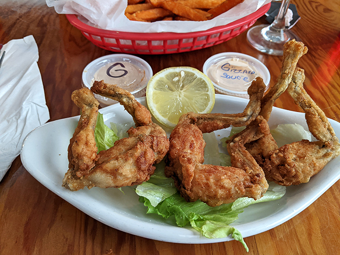 Golden-fried frog legs arrive like edible trophies, perched on crisp lettuce with dipping sauces that make you wonder why these aren't on every menu in America.