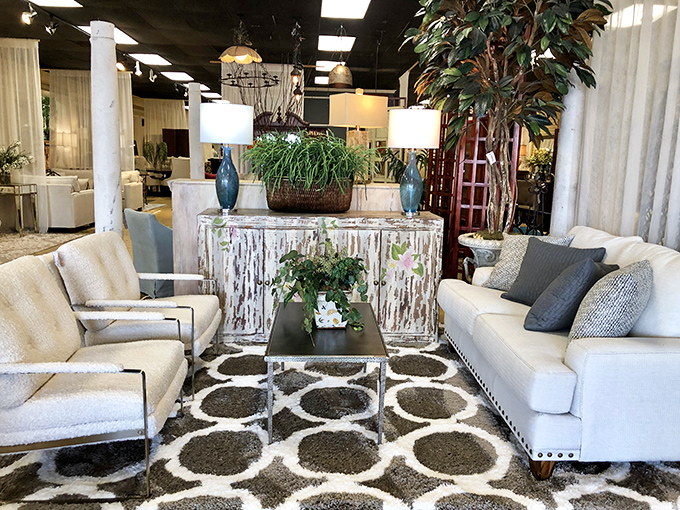 This coastal-inspired living room setup proves that distressed white furniture and geometric patterns are a match made in design heaven.