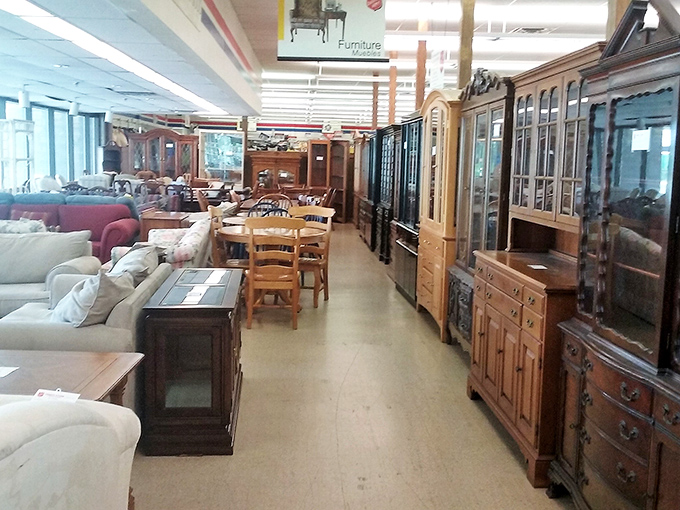 Solid wood furniture with stories to tell lines this aisle. That hutch probably witnessed more family dinners than most restaurants have served.