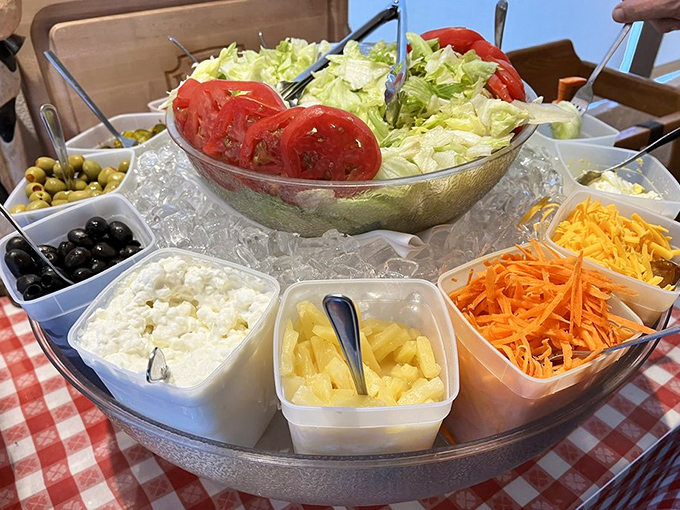 The salad bar's fresh simplicity balances the richness to come. Crisp lettuce and ripe tomatoes standing by, like opening acts for a rock star.