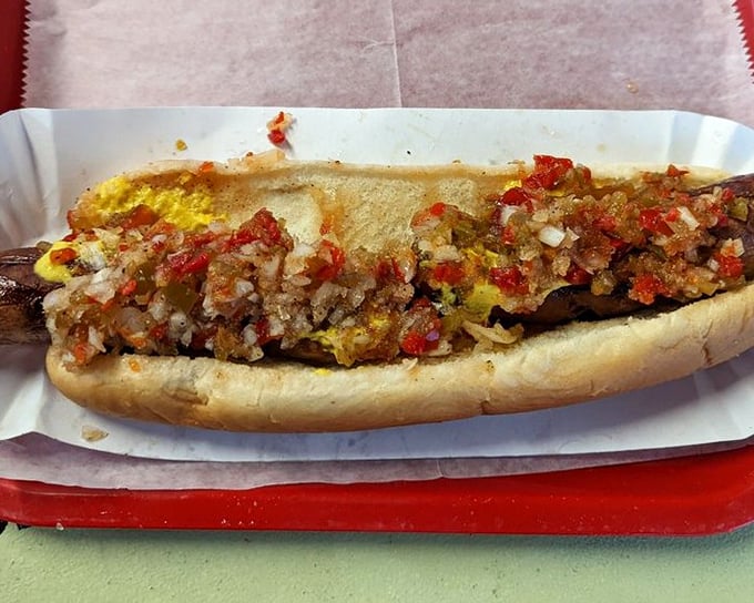 This isn't just a hot dog &ndash; it's a masterpiece of meat, mustard, and minced onions nestled in a soft bun that's worth every napkin you'll need.