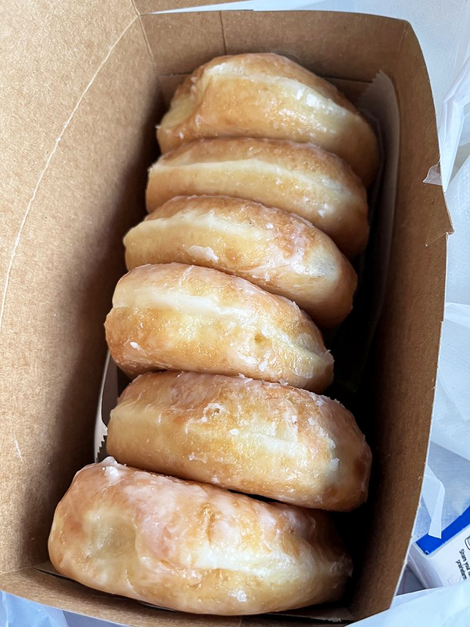 Golden pillows of perfection lined up like edible dominos. These glazed donuts aren't just breakfast&mdash;they're an Indianapolis rite of passage.