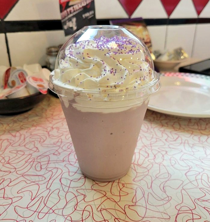 This isn't just any milkshake&mdash;it's a purple-sprinkled masterpiece that demands both a straw and a spoon, topped with whipped cream that defies gravity.