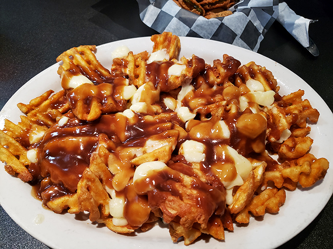 Behold the legendary gravy fries in all their glory! Golden waffle fries smothered in rich gravy and cheese curds&mdash;a plate that demands both a fork and your undivided attention.