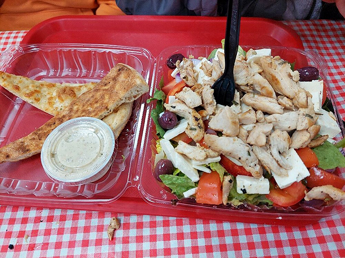 This Greek salad isn't just food&mdash;it's edible architecture, with grilled chicken, feta, olives, and fresh vegetables creating a colorful landscape of flavor.