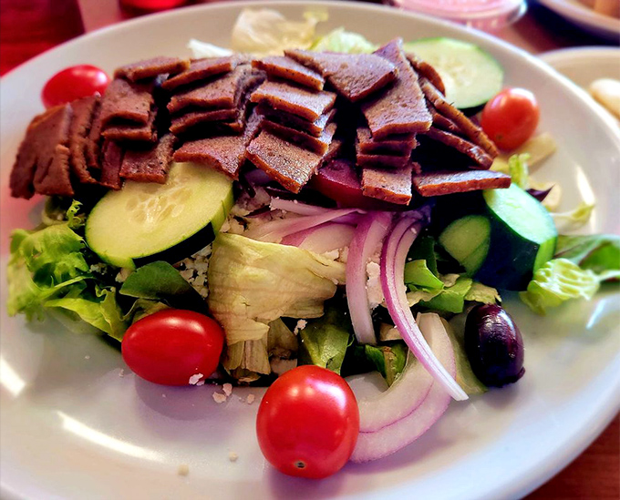 This isn't just any Greek salad &ndash; it's a masterpiece of crisp vegetables, briny olives, and generous gyro meat that would make Zeus himself weep with joy.