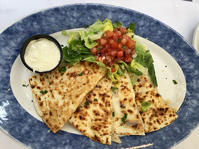 Golden-brown perfection that makes you question everything you thought you knew about quesadillas. The crispy exterior gives way to melty cheese and perfectly seasoned chicken.