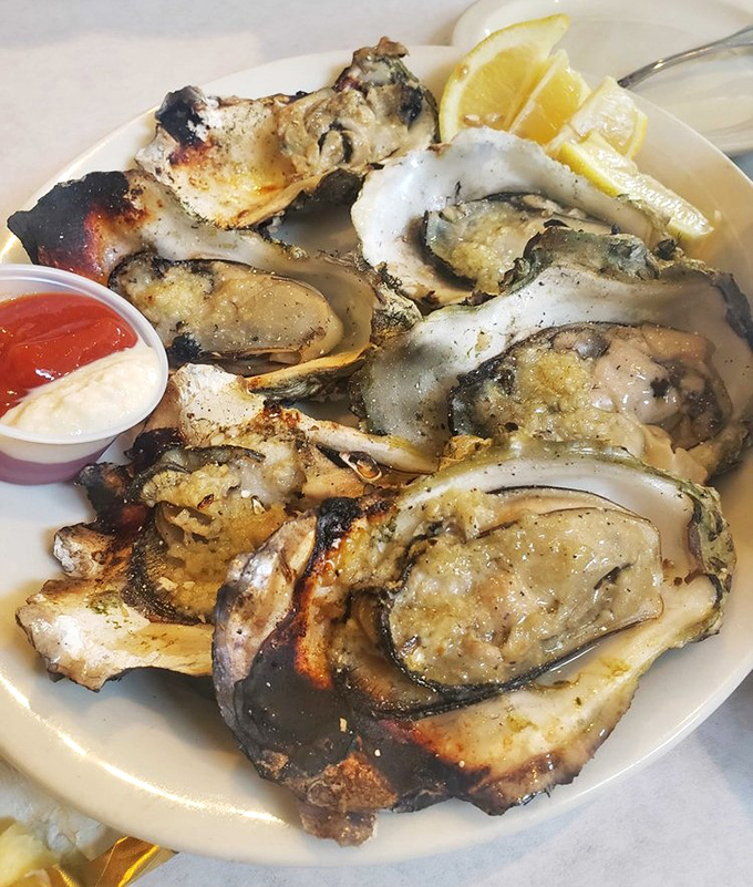 These oak-grilled oysters aren't just seafood; they're a religious experience with butter and garlic playing the roles of divine messengers.