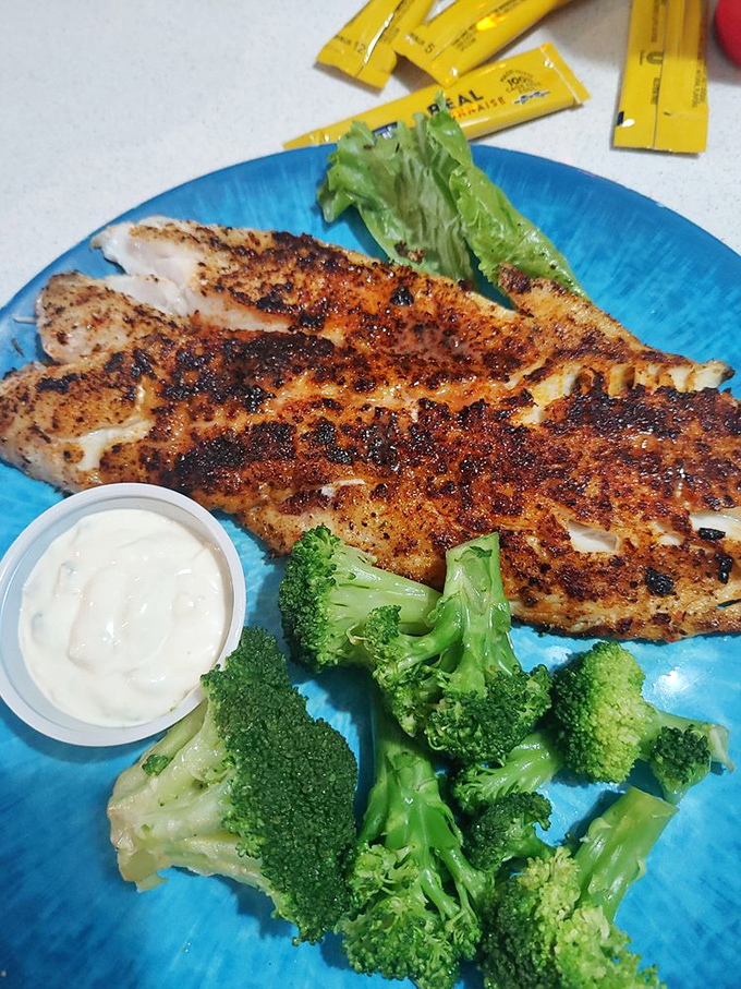 Blackened to perfection, this fish wears its seasoning crust like a badge of honor, while staying impossibly moist inside—seafood nirvana on a plate.