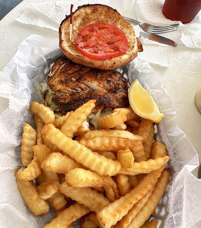 This blackened grouper sandwich isn't just lunch &ndash; it's a religious experience with a side of perfectly crispy fries and mandatory lemon squeeze.
