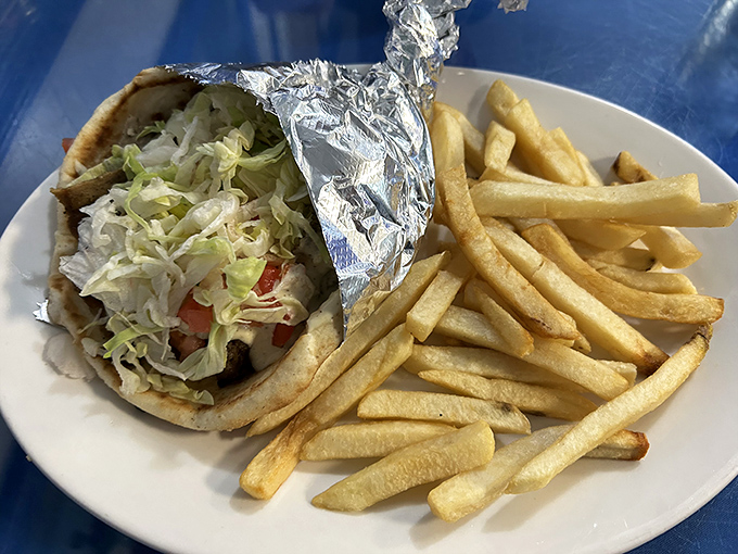 This isn't just any gyro &ndash; it's a masterpiece of tender meat, fresh veggies, and that signature tzatziki sauce that'll haunt your dreams for weeks.
