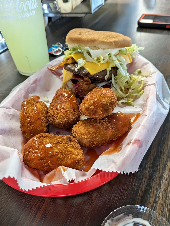 The Oh Boy burger arrives like a celebrity, surrounded by crispy sidekicks. Your diet plan just called to say it's taking the day off.
