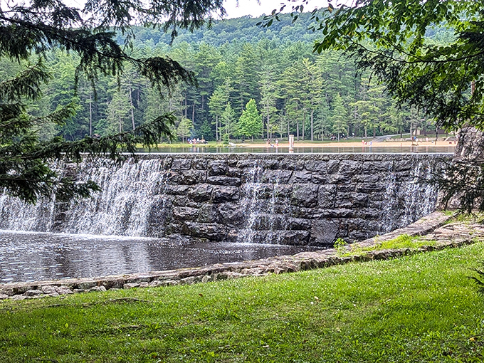 Water cascading over the stone dam creates nature's white noise machine—better than any sleep app you've downloaded.