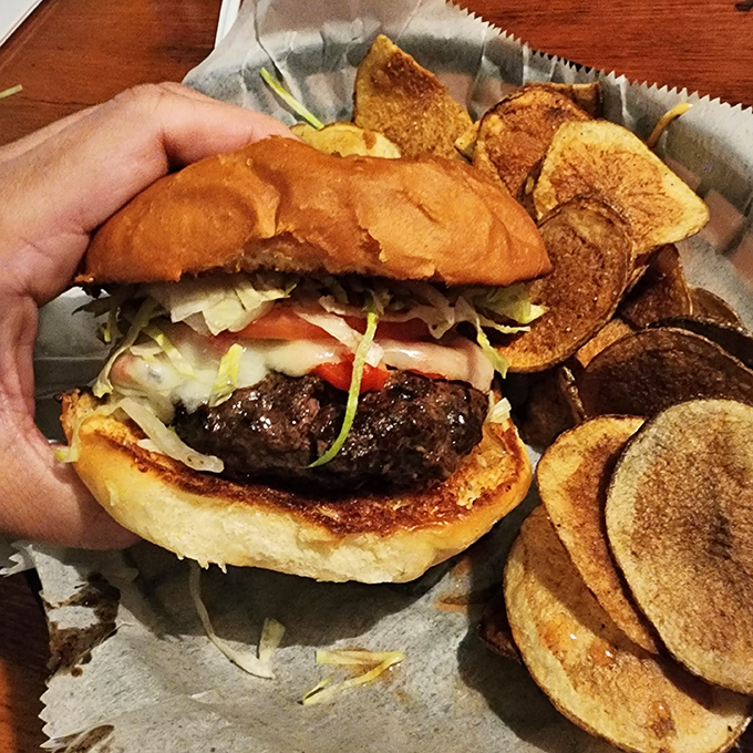 This isn't just a hamburger&mdash;it's a juicy masterpiece demanding two hands and your full attention. Those house-made kettle chips aren't playing second fiddle to anyone.