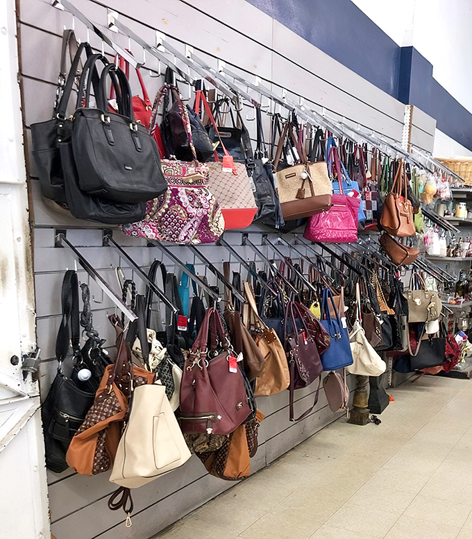 Handbag heaven! Designer dreams hang in suspended animation, waiting for their second act. The leather lineup looks like a fashion runway's greatest hits collection.