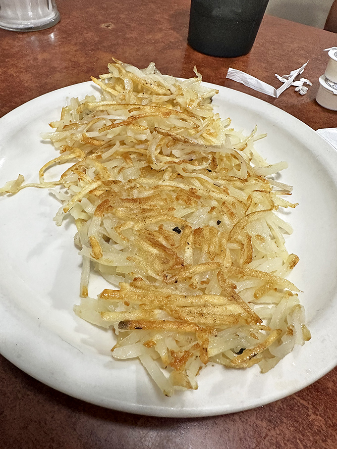 These hash browns deserve their own zip code &ndash; crispy, golden perfection that makes you wonder why anyone would ever eat potatoes any other way.