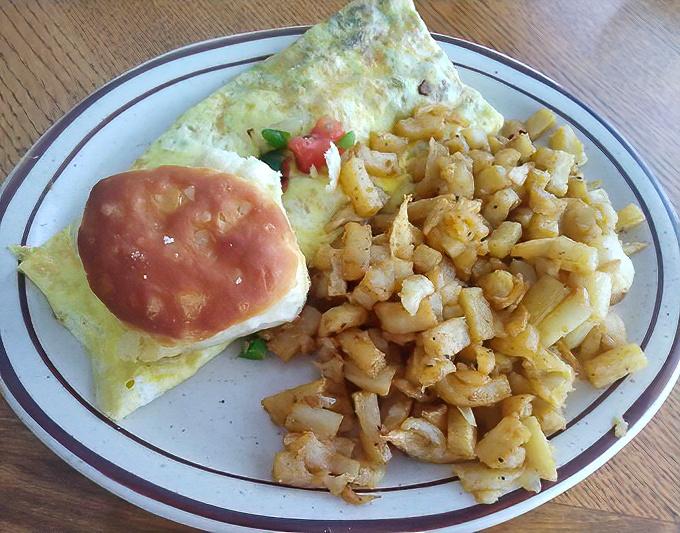 Hash browns that could make a potato farmer weep with pride share the plate with a veggie omelet bursting with fresh ingredients.
