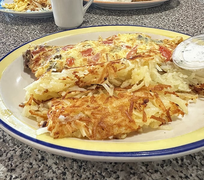 Golden, crispy hashbrowns that shatter like delicate glass with each bite, paired with a perfectly cooked omelet &ndash; this is breakfast nirvana, Wisconsin-style.