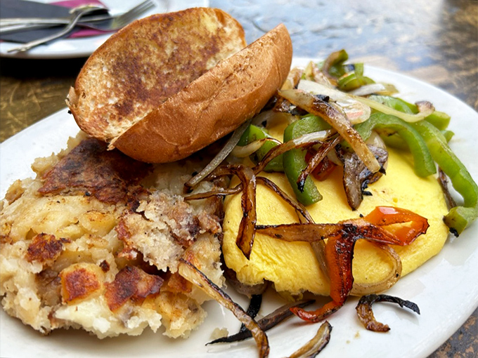 Savory meets spectacular in this omelet masterpiece. Those hash browns have achieved the perfect crisp-to-tender ratio that haunts breakfast dreams.