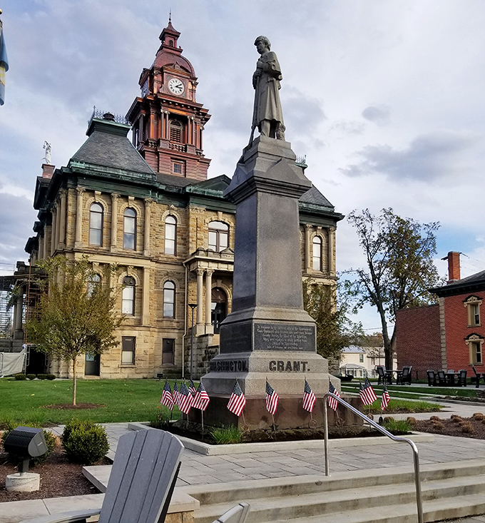History stands at attention beside the courthouse, where a Civil War monument honors those who served while American flags flutter in the Ohio breeze.