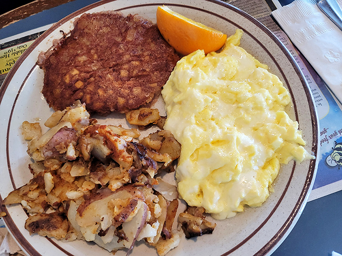 Behold the holy trinity of breakfast perfection: golden home fries, fluffy scrambled eggs, and crispy scrapple that would make any Delawarean proud.